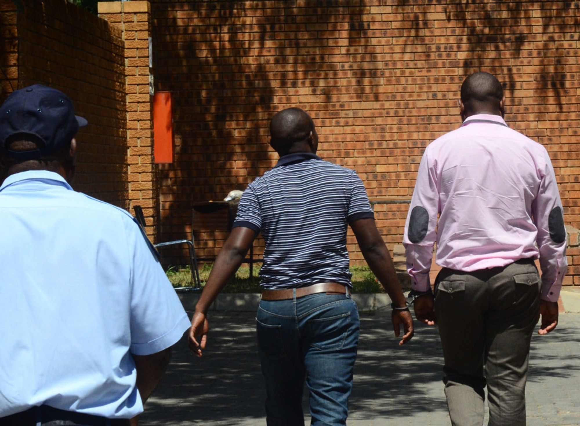 Officers on robbery rap still in jail