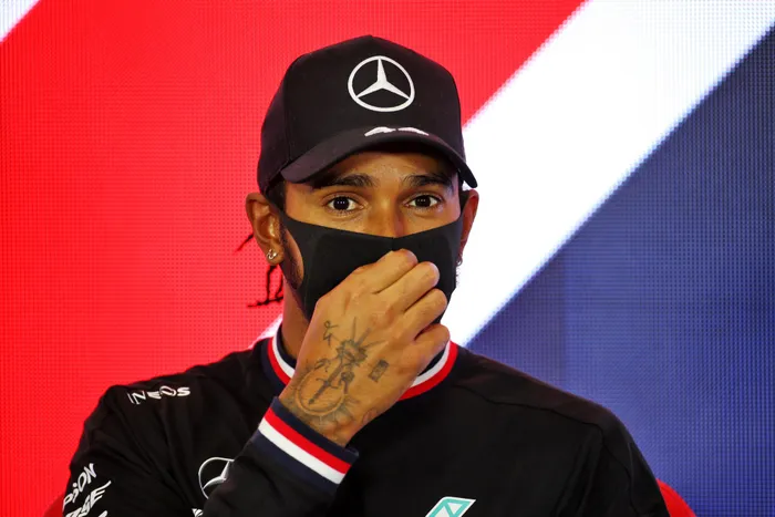 Hamilton credits survival instinct for three-wheeled win