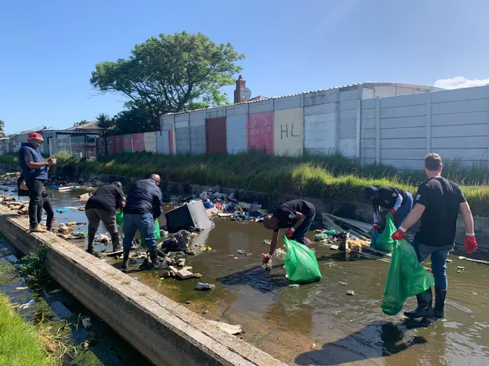Legislators get their hands dirty cleaning up a canal in Hazendal