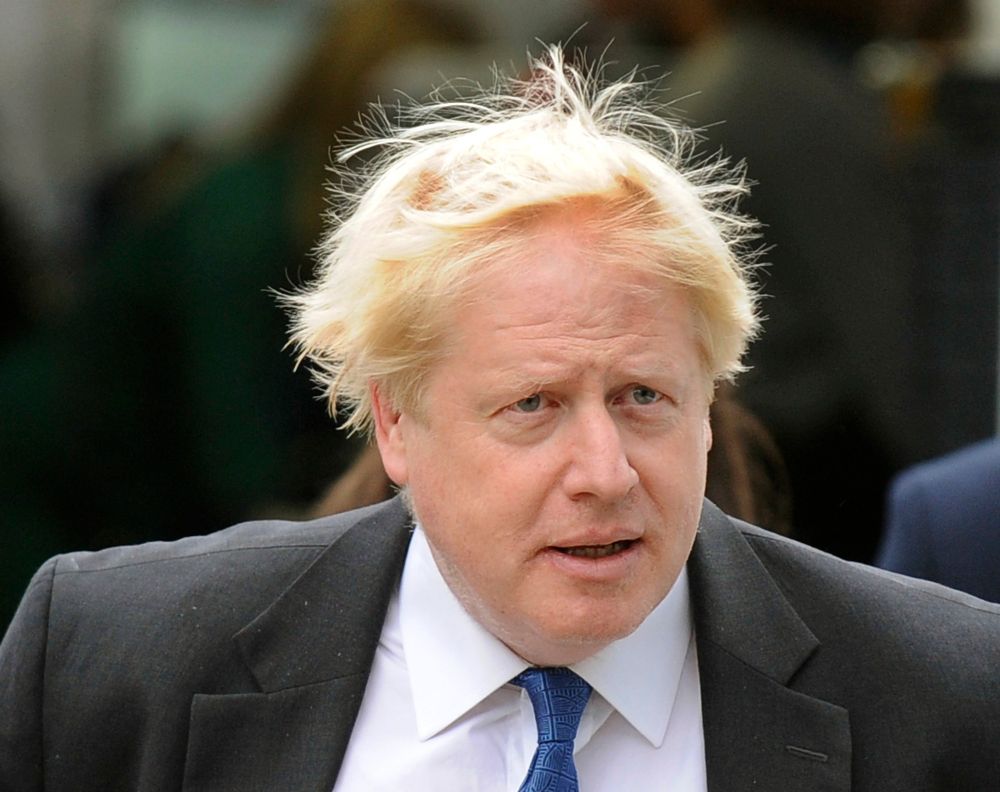 Johnson assaults May's Brexit plan at fractious party meeting