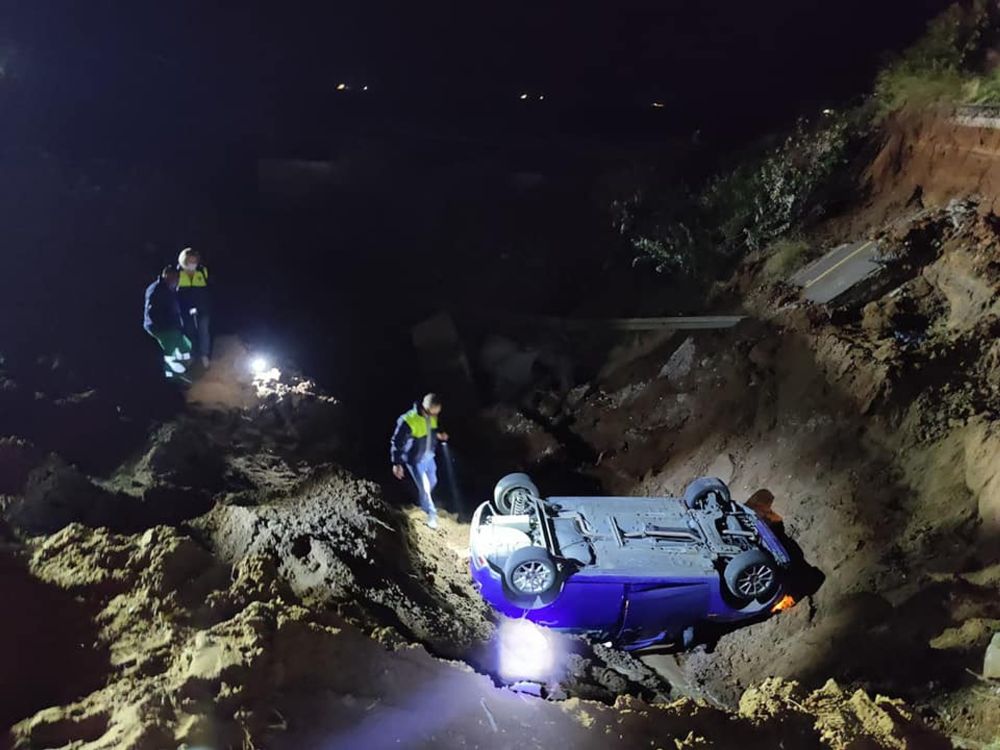 PICS: Four people injured as car plunges down washed away road