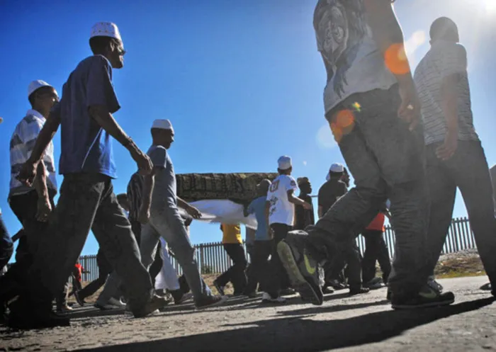 Residents gather at slain man’s funeral