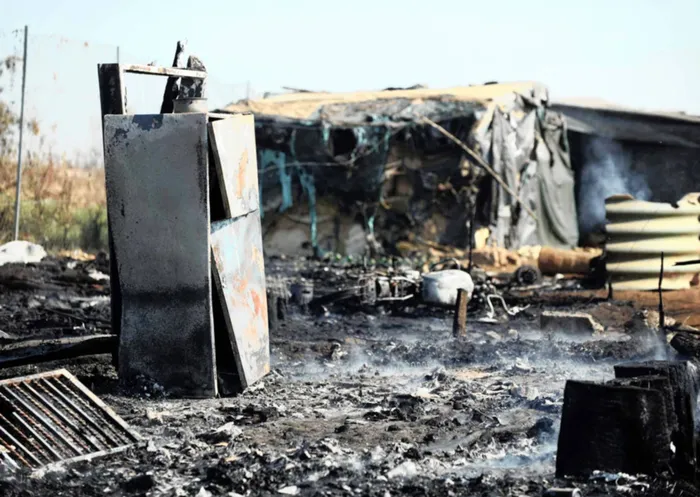 Fire razes Woodlane Village shacks