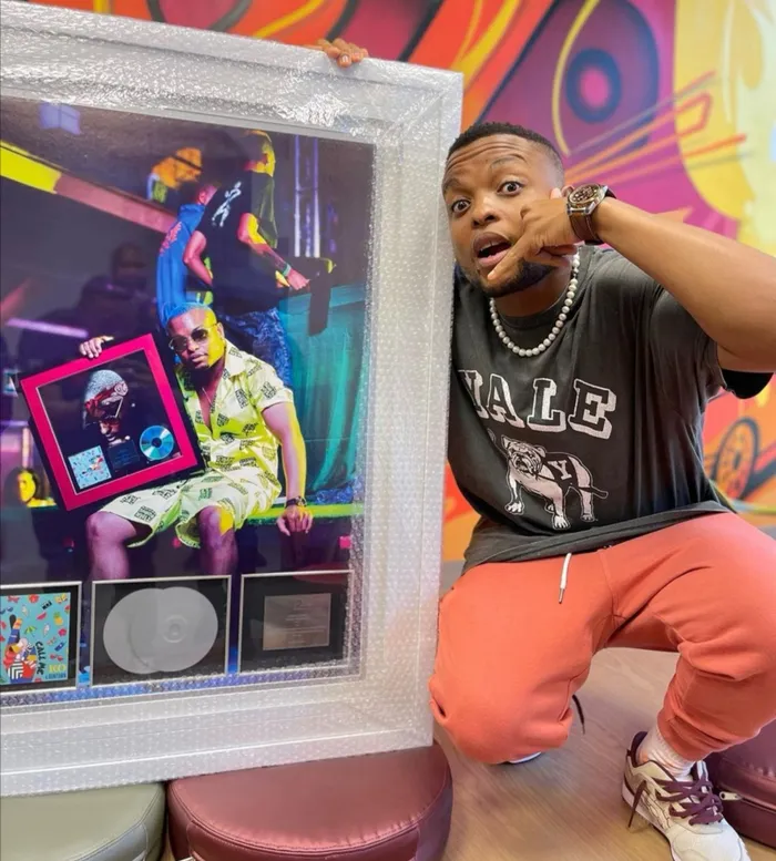 K. O presented with three platinum plaques on his birthday