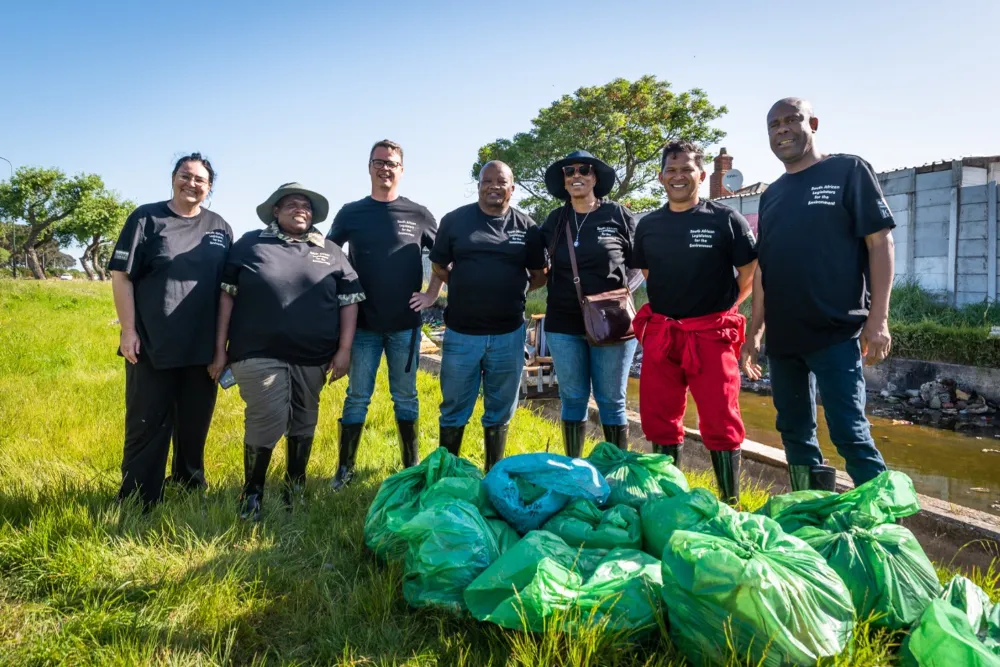 Legislators get their hands dirty cleaning up a canal in Hazendal