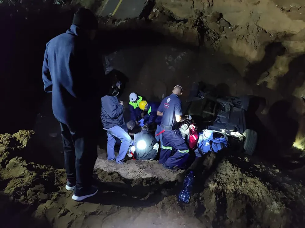 PICS: Four people injured as car plunges down washed away road
