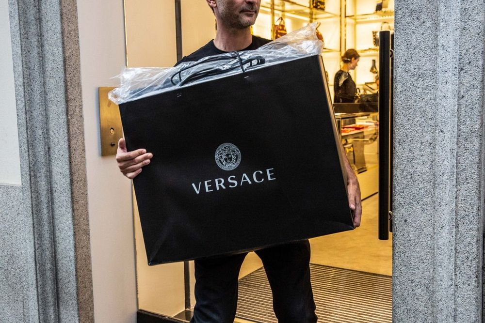 Michael Kors buys high-fashion label Versace
