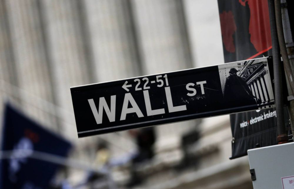 Wall Street ticks up on economy bets