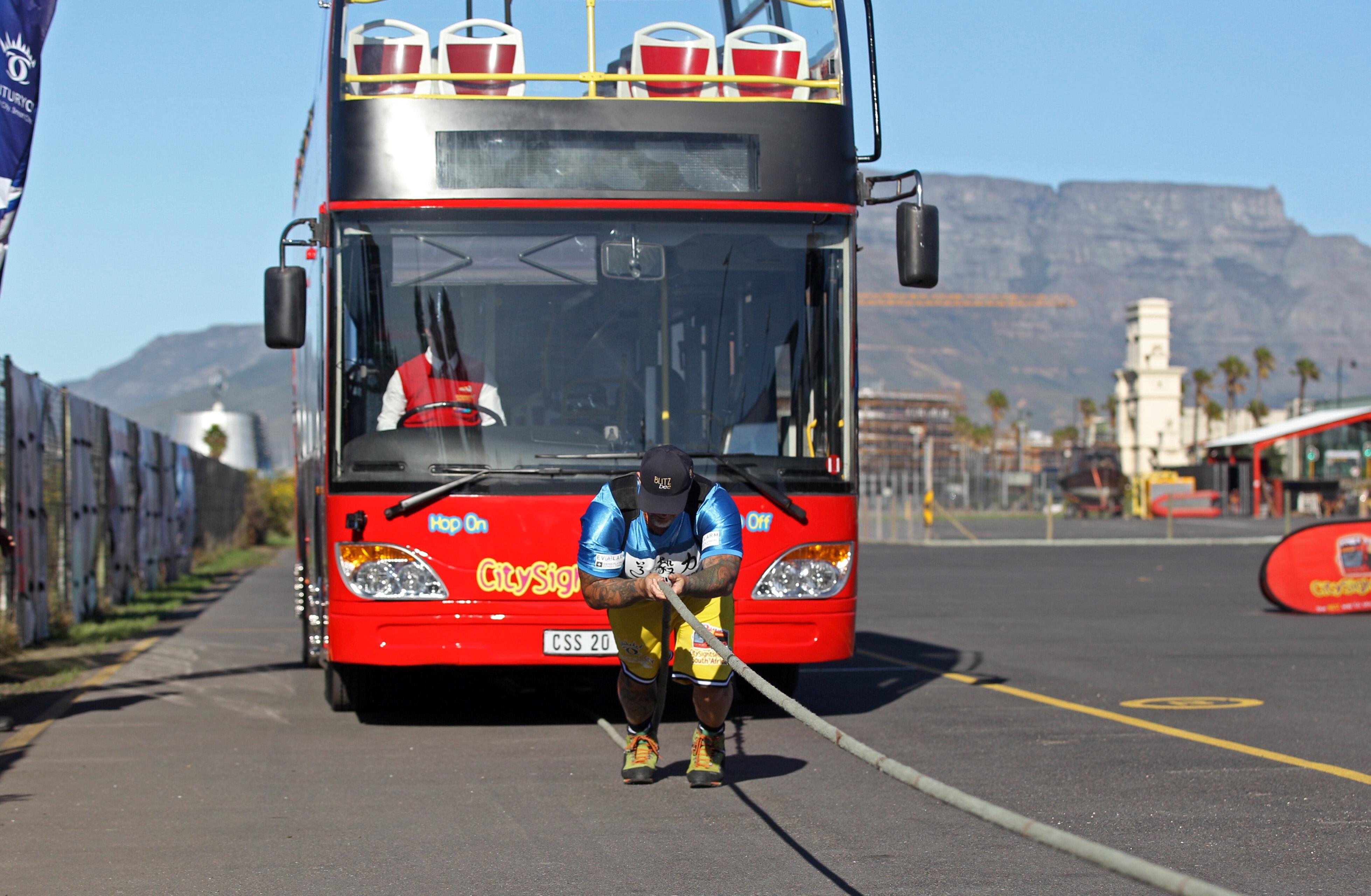 Franz Müllner sets world record by pulling a double-decker bus in ...
