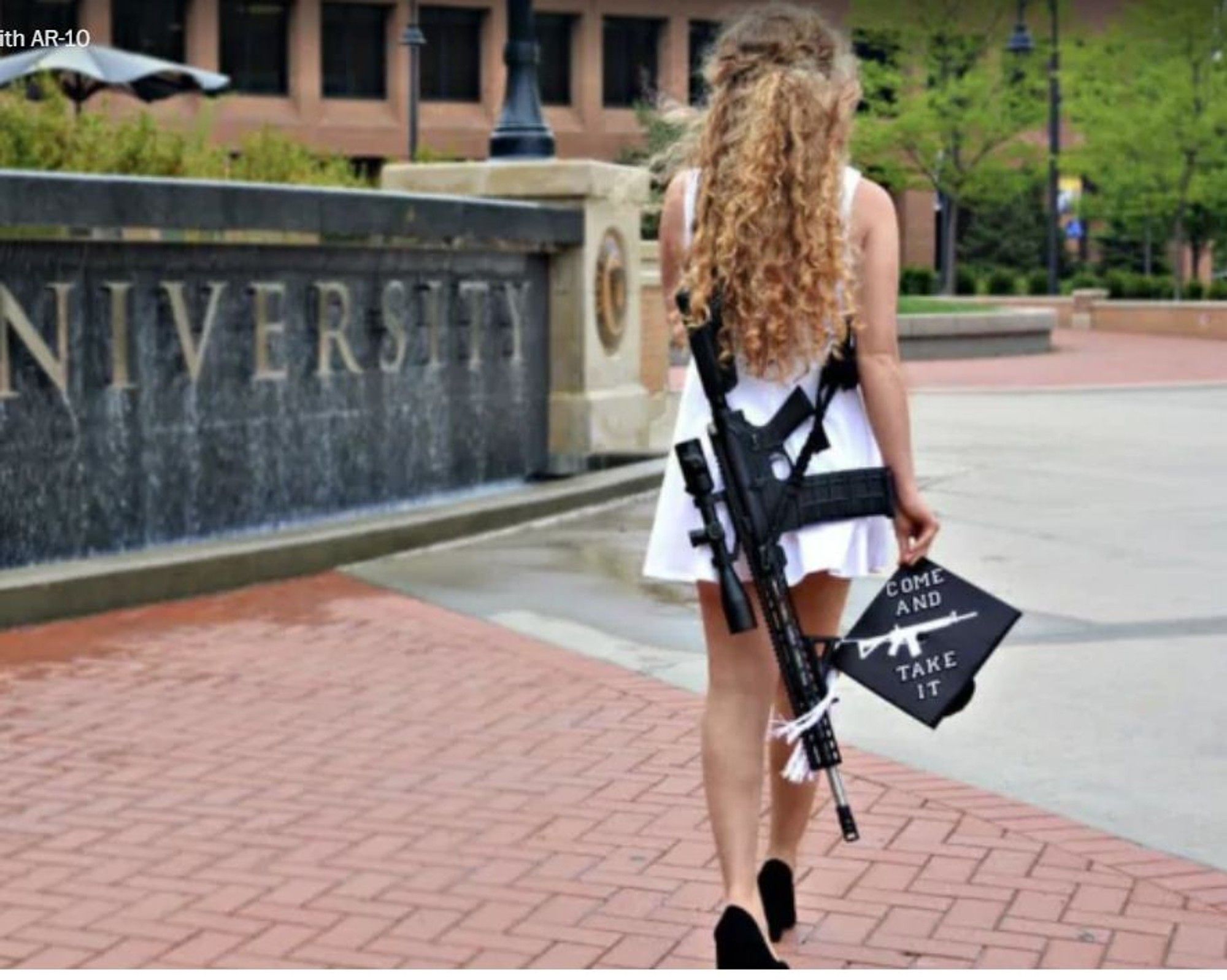 The story behind the viral pic of the varsity graduate and her rifle