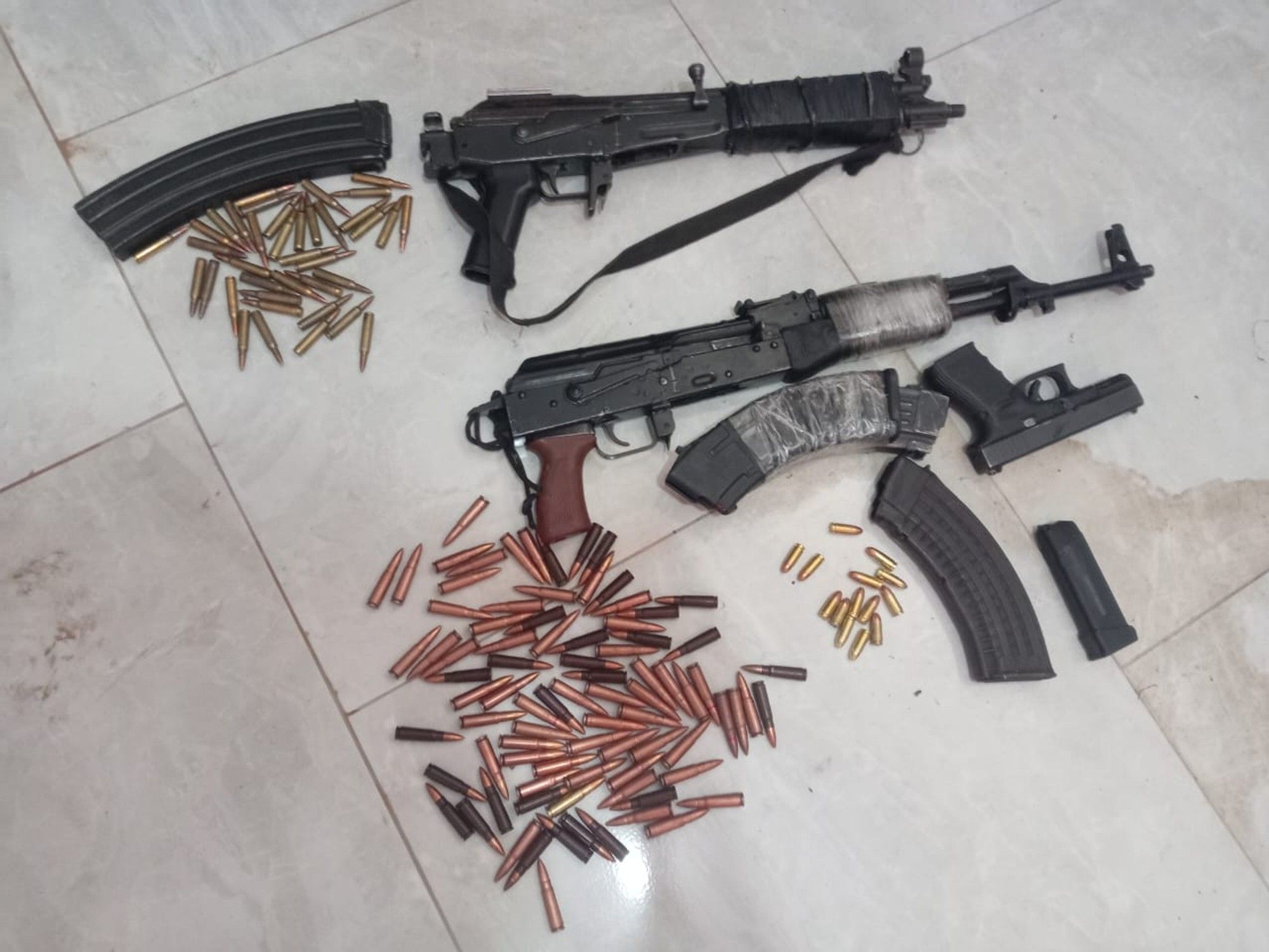 Three in cuffs after high calibre weapons and SANDF uniform seized in ...