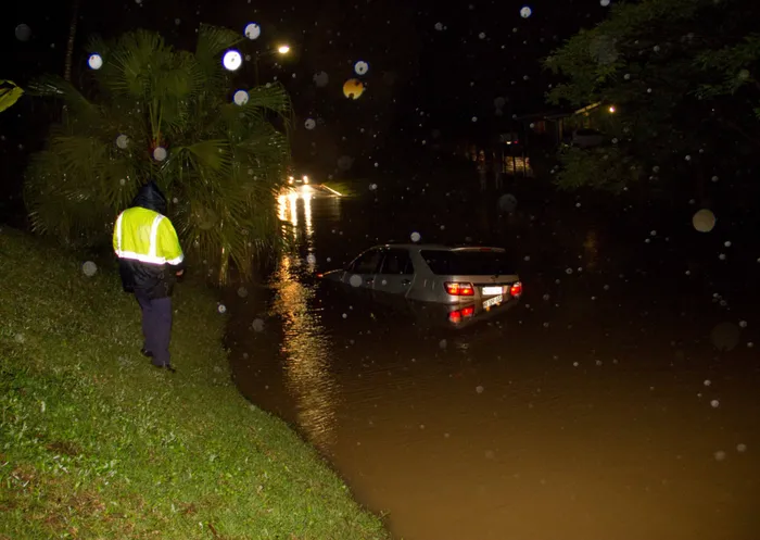 Surfer rescues driver from flood
