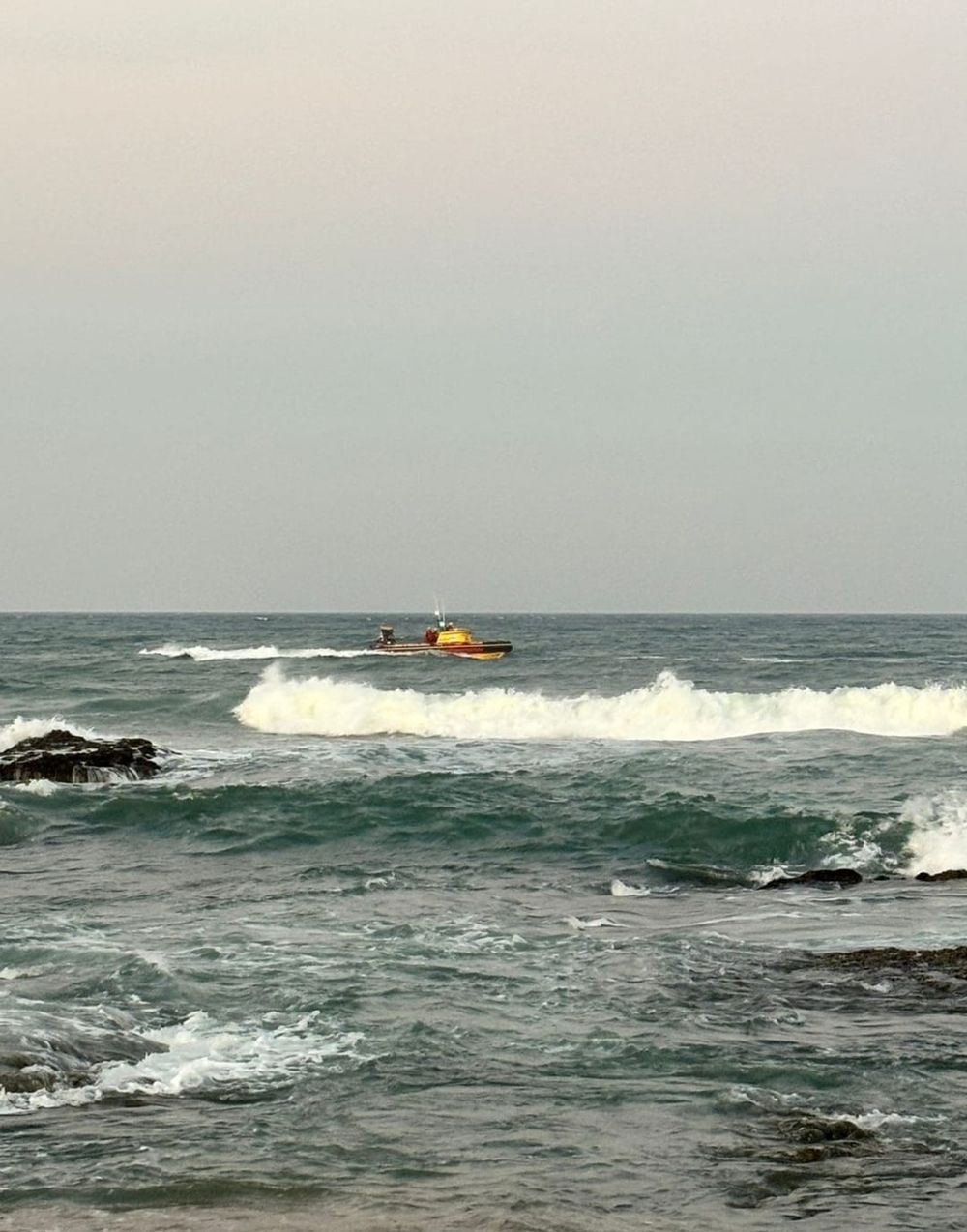 Son launches surfboard to help dad swept out to sea after boat capsizes
